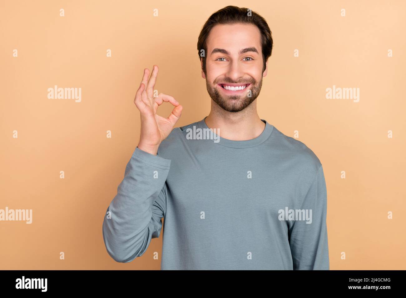 Photo of young cheerful guy show fingers okey symbol perfect feedback ...