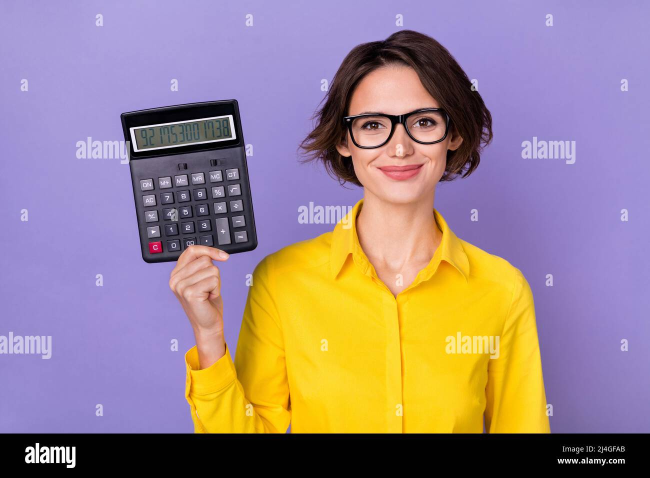 Photo of smart millennial lady hold calculator wear yellow outfit ...