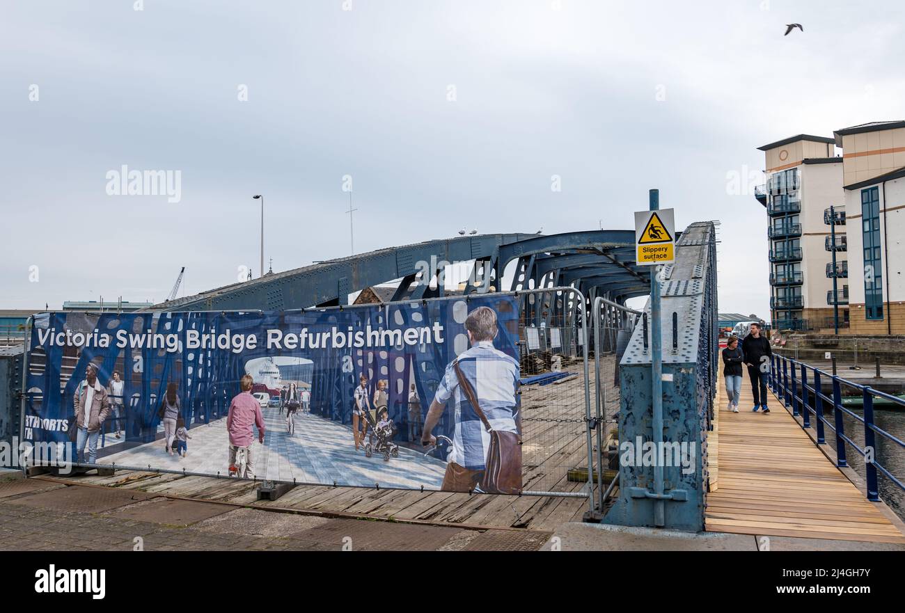 People walking on walkway of old Victoria swing bridge under ...