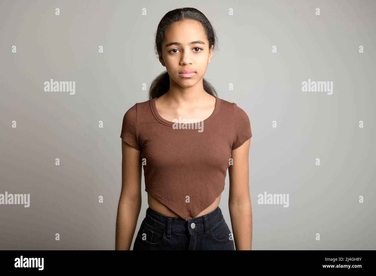 Beautiful black teen posing on studio gray background Stock Photo - Alamy