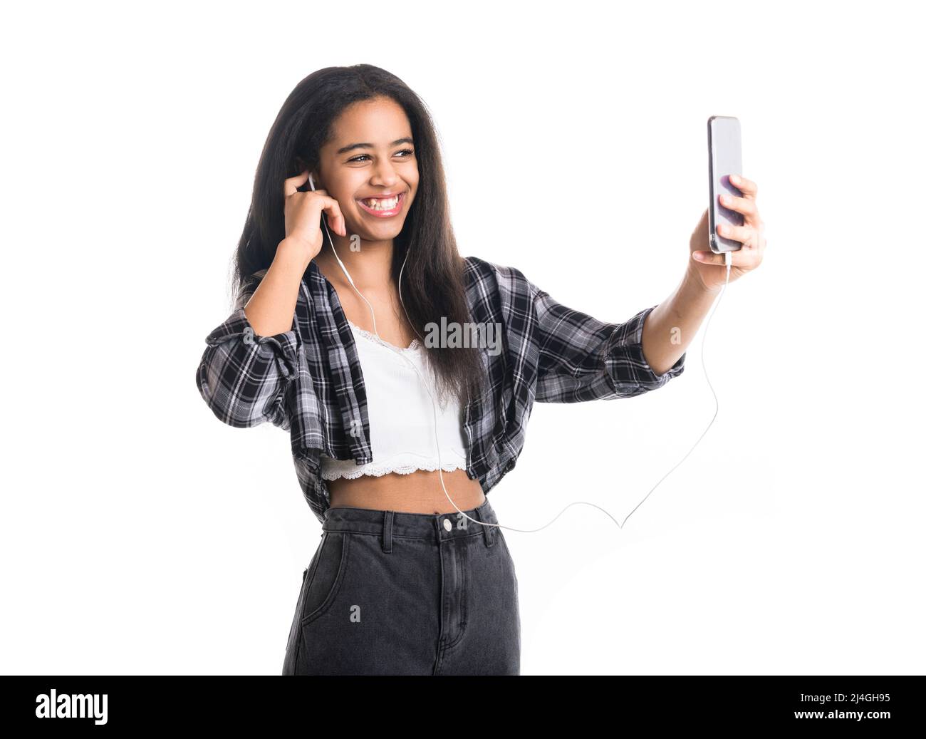 Beautiful black teen posing on studio white background with cellphone ...