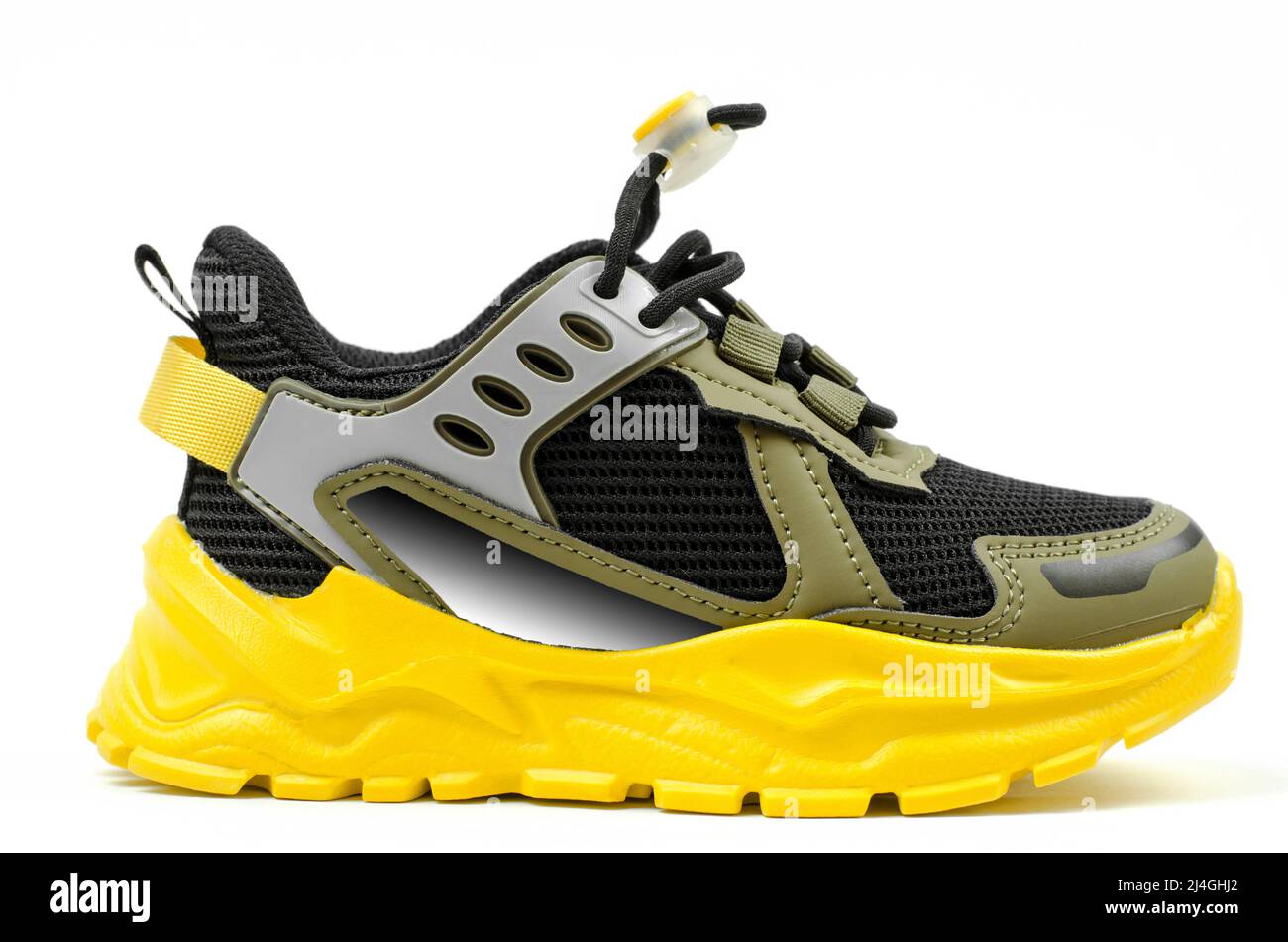 Sports sneaker with yellow sole isolated on white background. Khaki ...