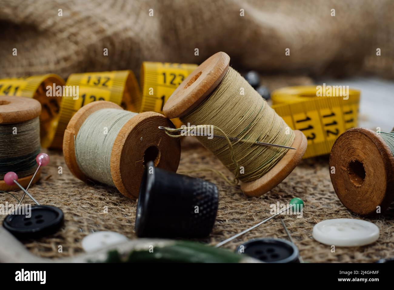 Retro tools for cutting and sewing. Needle with thread, thimble, sewing ...