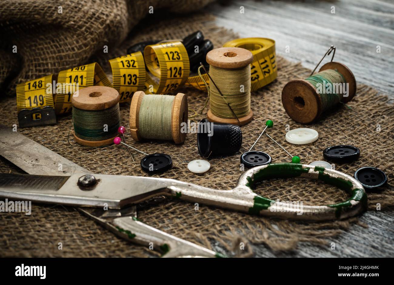 Retro tools for cutting and sewing. Needle with thread, thimble, sewing ...