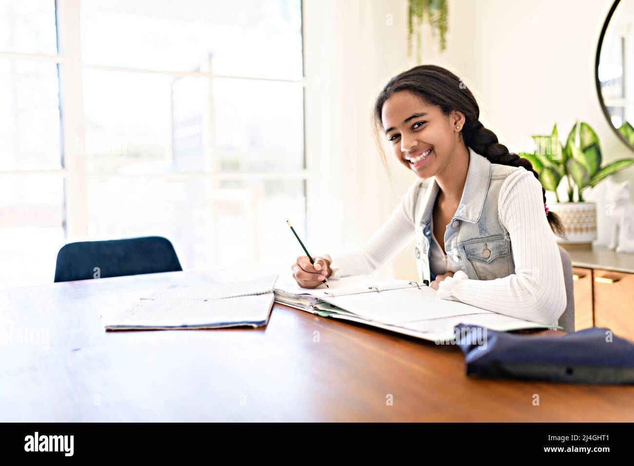 American teen girl learning school tasks at home, writing notes Stock ...