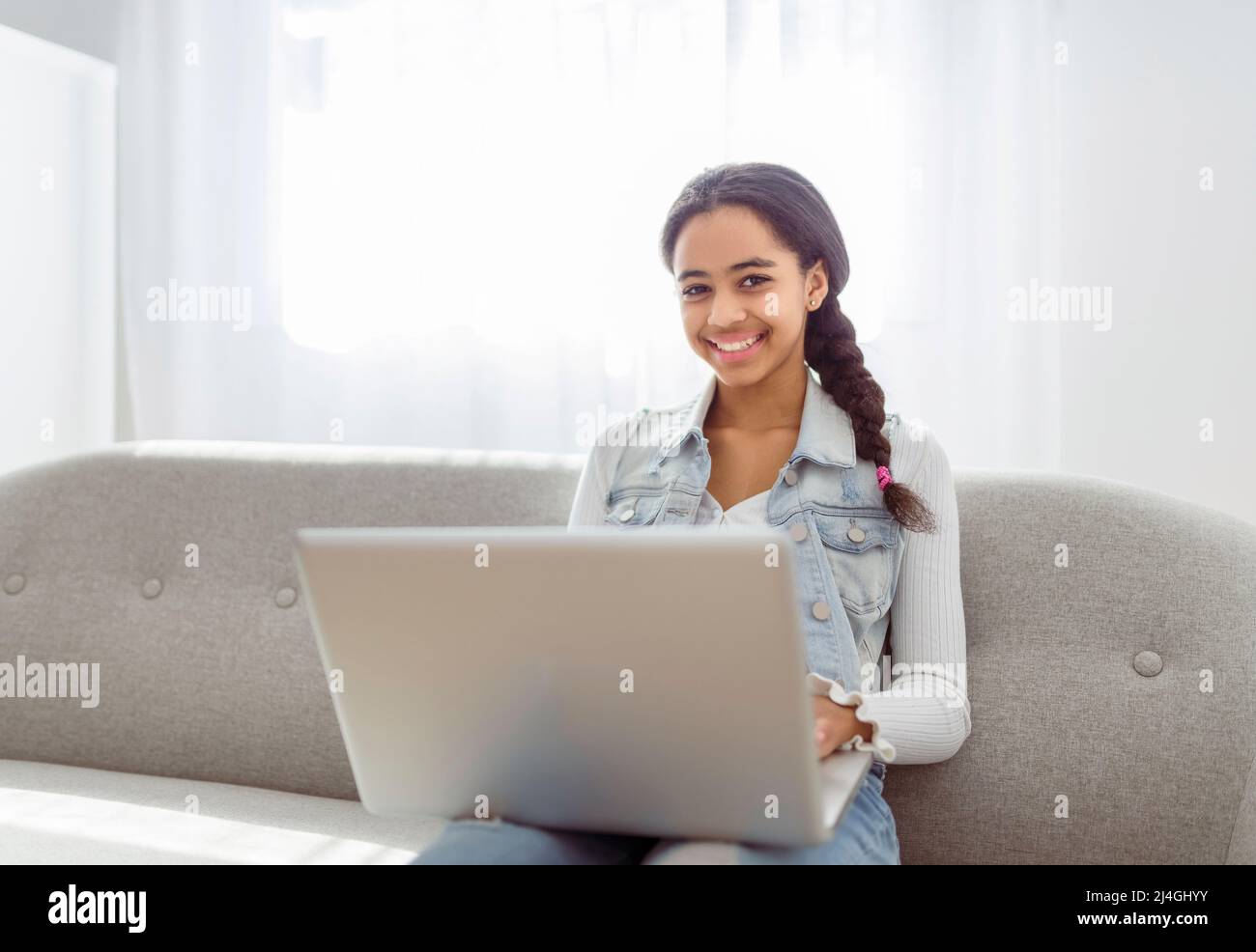 African Teen Girl Using Laptop Computer Browsing Internet Sitting On ...