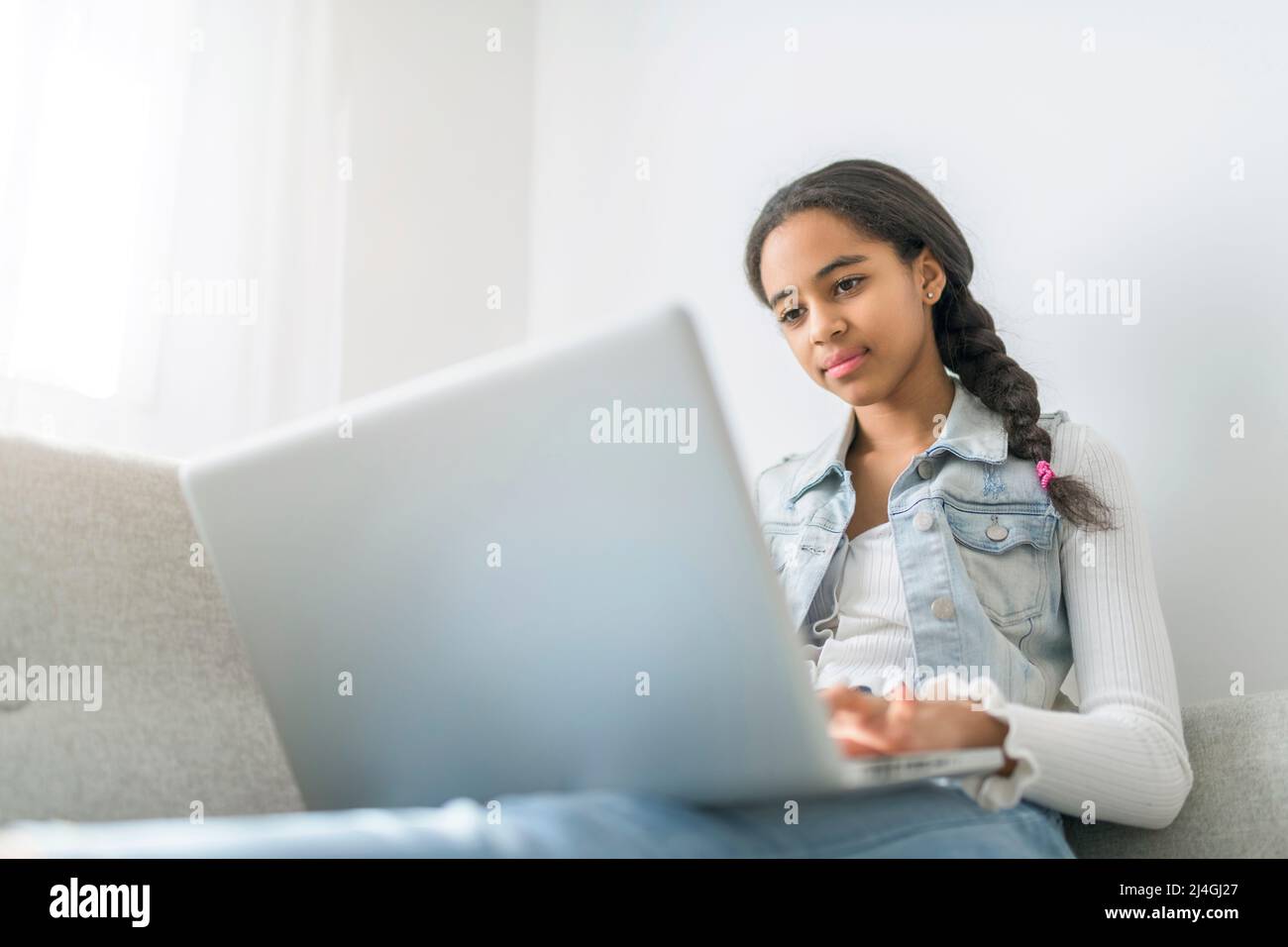 African Teen Girl Using Laptop Computer Browsing Internet Sitting On ...