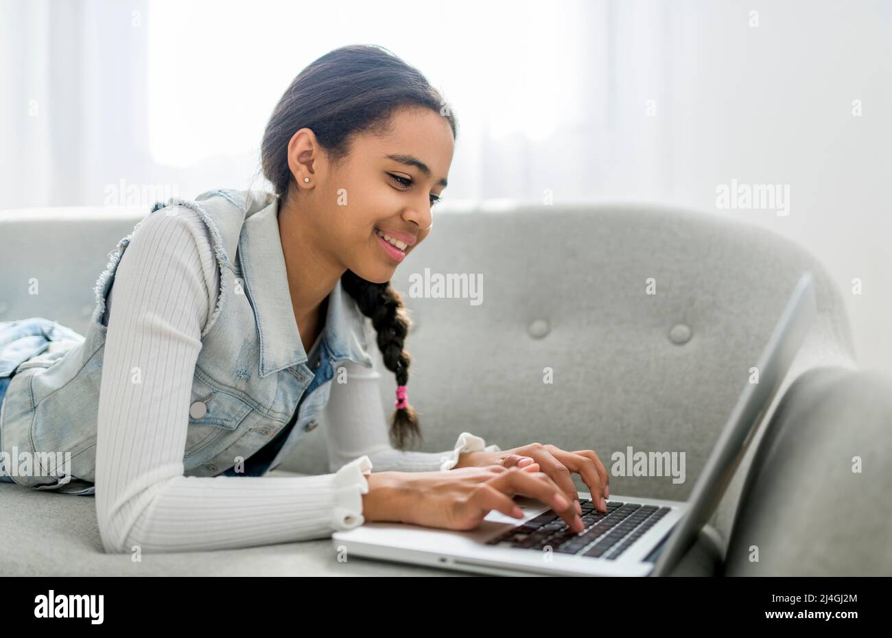 African Teen Girl Using Laptop Computer Browsing Internet Sitting On ...