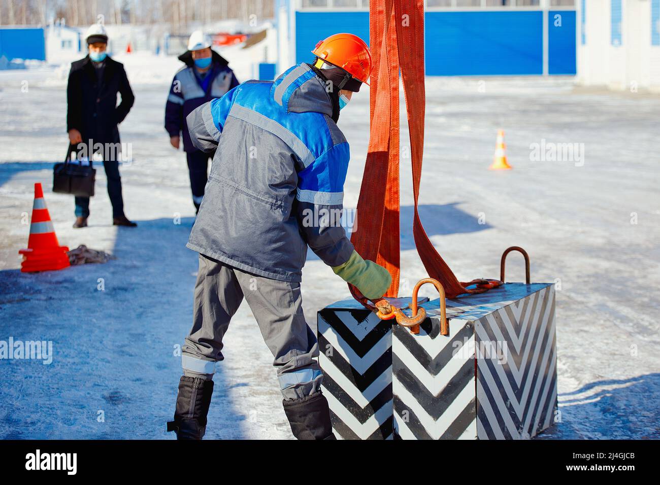 Working slinger passes exam on lifting loads. Real scene. Commission ...