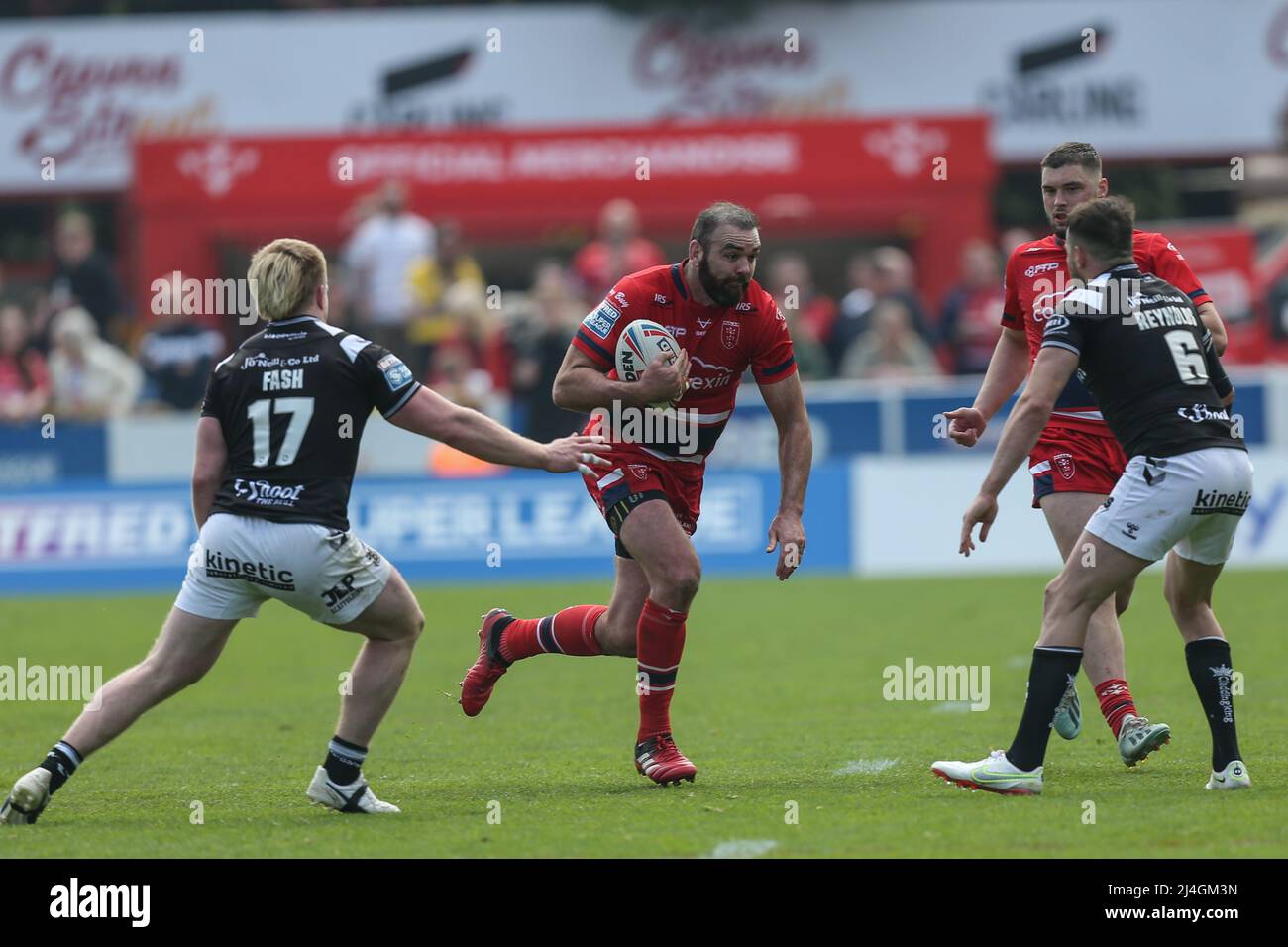 Kane Linnett #12 of Hull KR makes a run at Josh Reynolds #6 of Hull FC ...