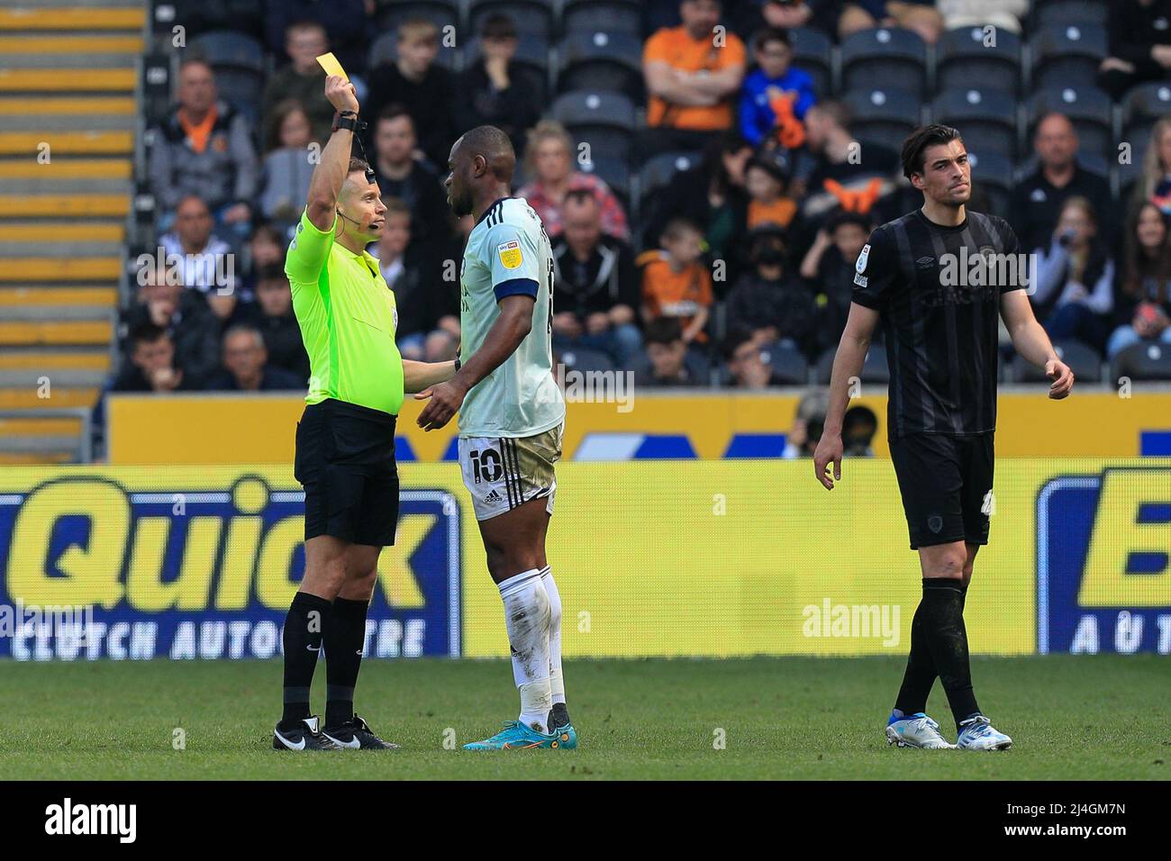 Hull, UK. 15th Apr, 2022. Referee Stephen Martin awards a yellow card to Uche Ikpeazu #10 of ...