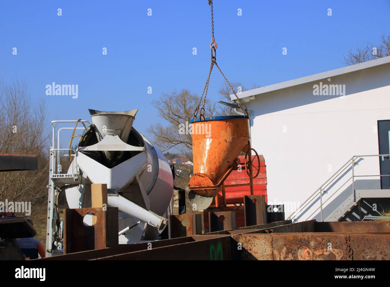 Transporting liquid concrete on a construction site through a concrete ...