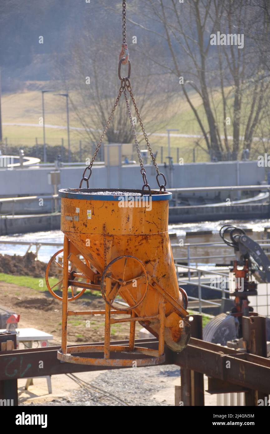 Transporting liquid concrete on a construction site through a concrete ...