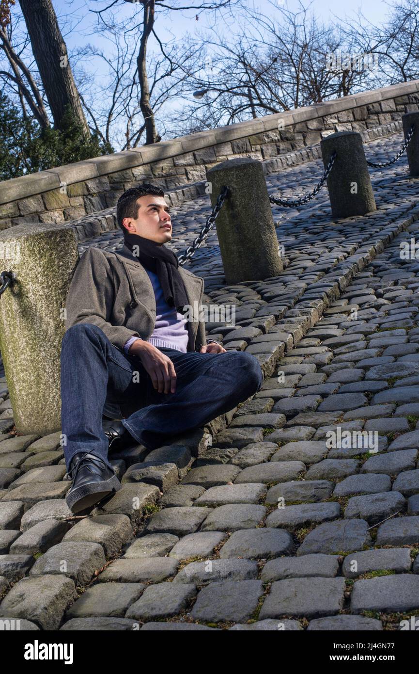 A young guy is lay on the ground, hopefully looking up Stock Photo - Alamy