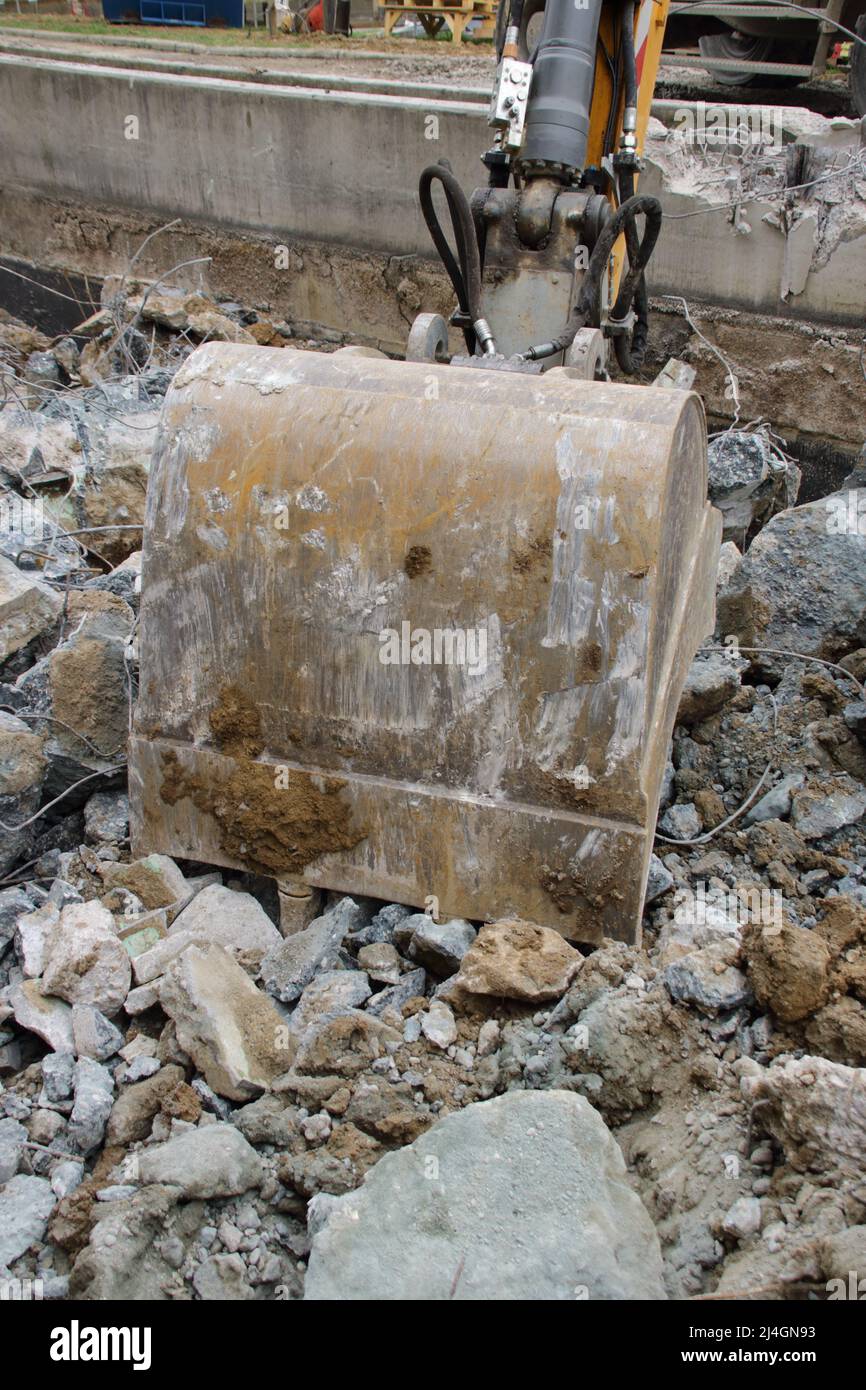 Loading construction rubble with an excavator in a dusty environment ...