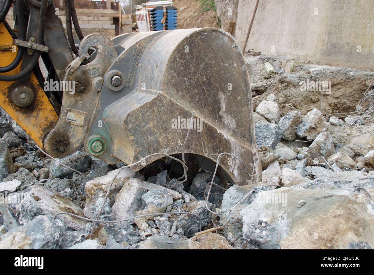 Loading construction rubble with an excavator in a dusty environment ...