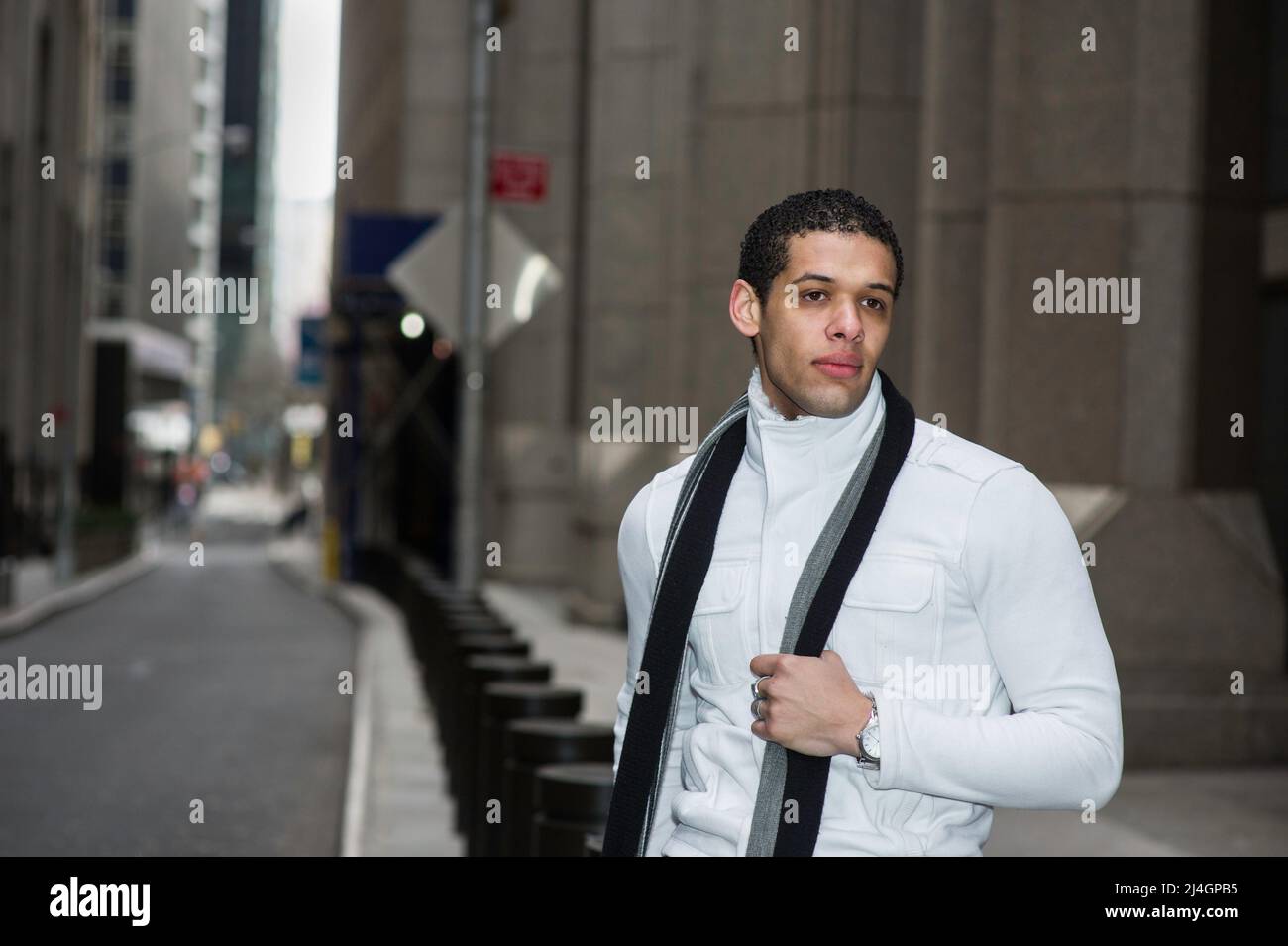 A young college student is sitting by a street and into deeply thinking ...