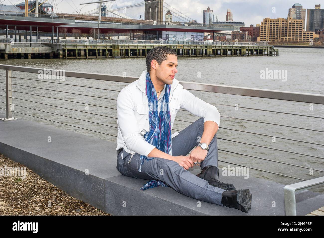 A young student is sitting by a river and into deeply thinking Stock ...