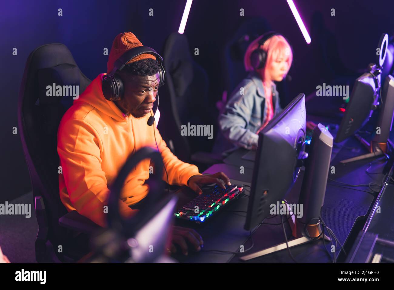 Team of professional esport gamers with happy African man in focus ...