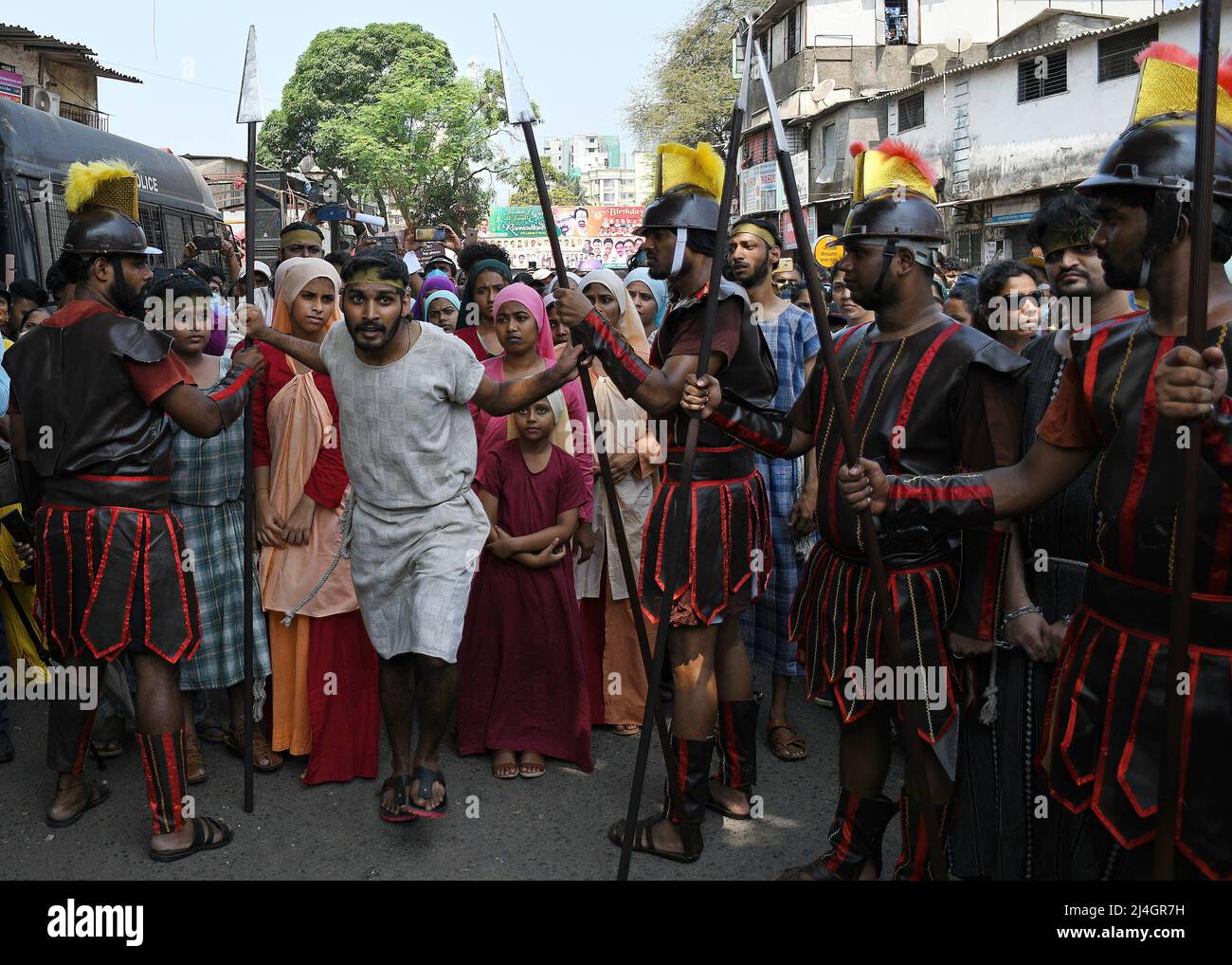 People participate in a re-enactment during a Good Friday procession ...