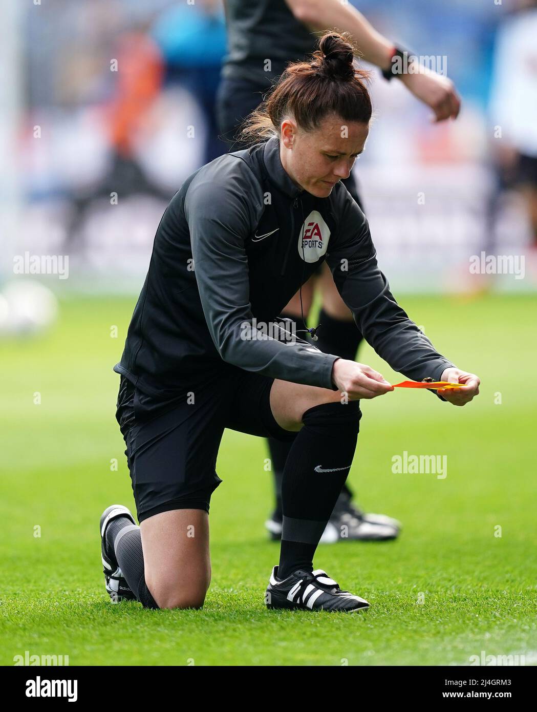 Fourth official Rebecca Welch uses red and yellow cards to take a Bee ...