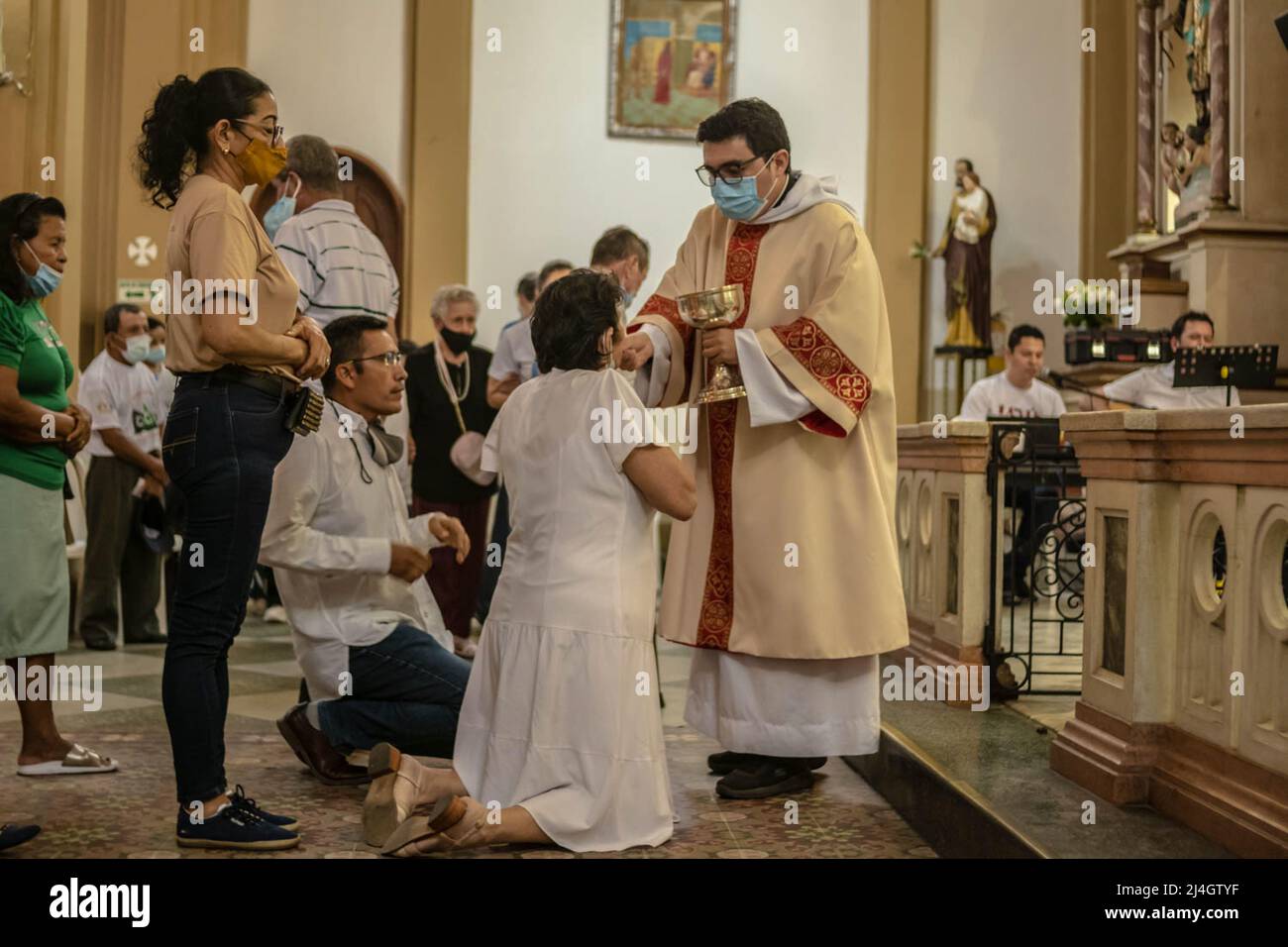 People attend the Sacrament of Eucharist Mass during the holy week ...