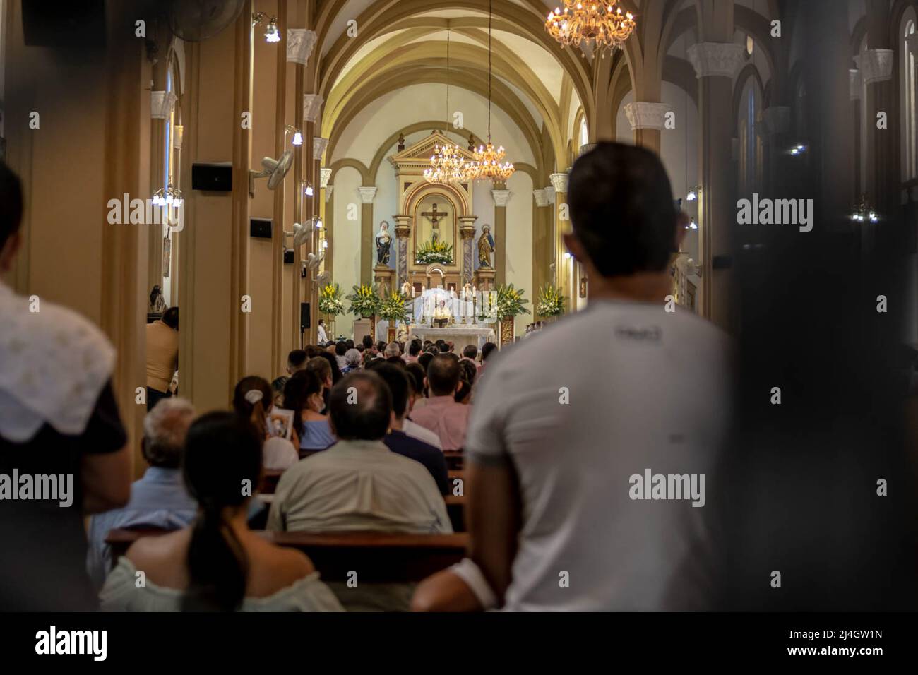 People attend the Sacrament of Eucharist Mass during the holy week ...