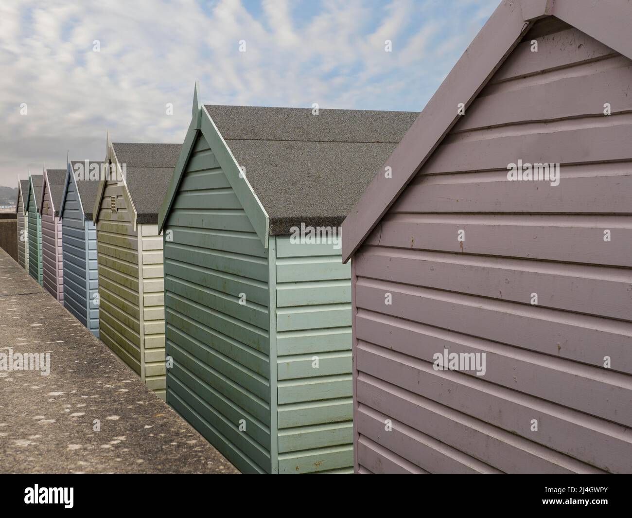 row of beach huts from behind, Avon Beach, christchurch, Dorset, UK ...