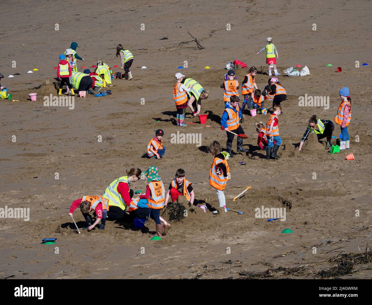 Young school children on a field trip to the beach, Bude, Cornwall, UK ...