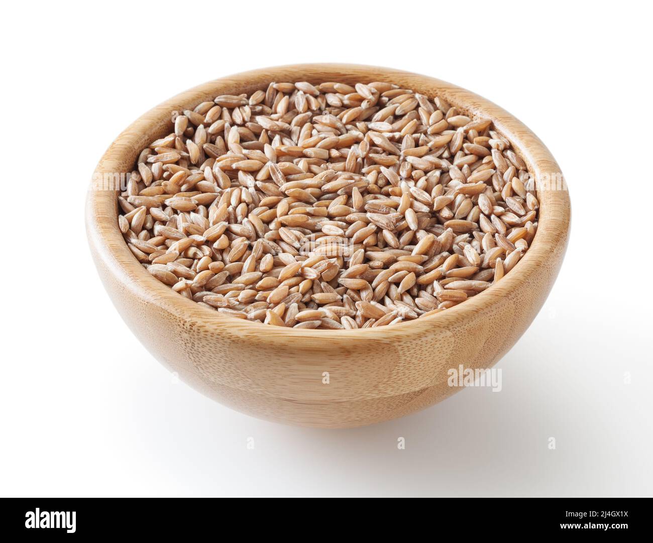 Grains of spelt in wooden bowl isolated on white background wiht ...