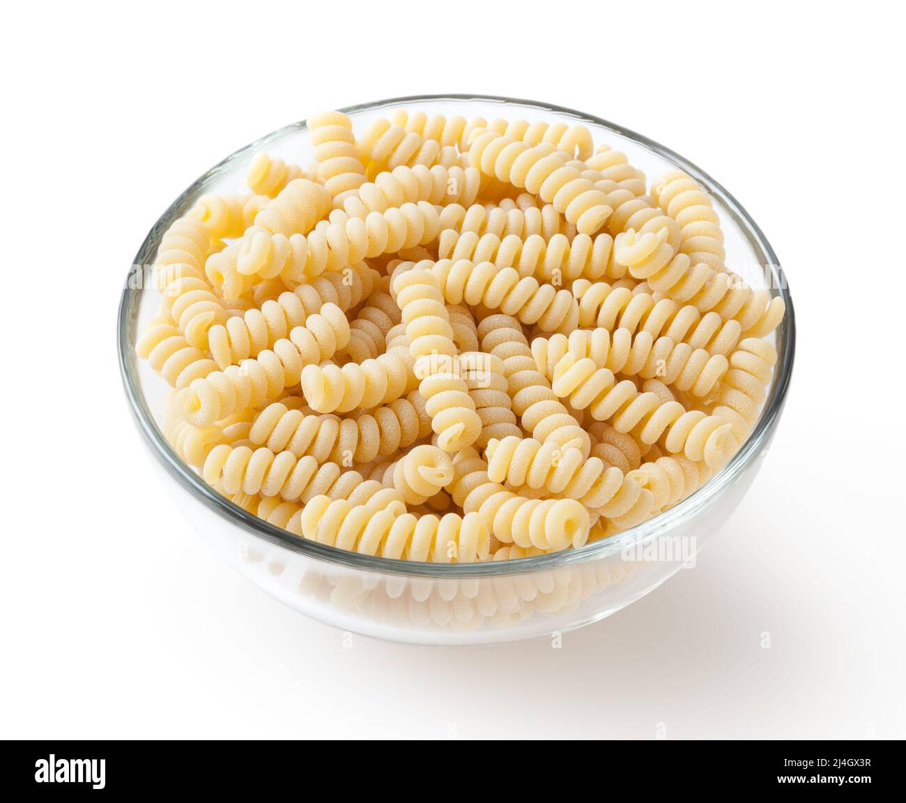 Uncooked fusilli corti bucati pasta in glass bowl isolated on white ...