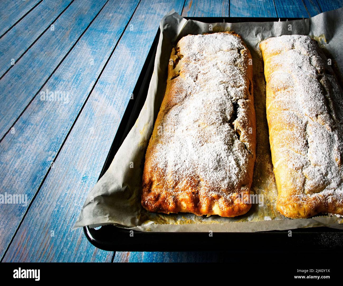 food background freshly baked strudel on a baking sheet Stock Photo - Alamy