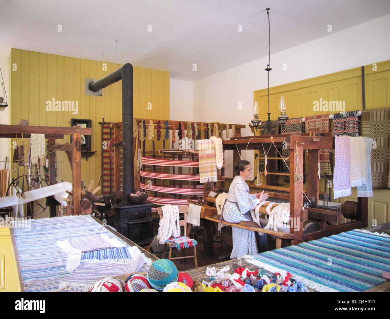 Toronto, Canada - 08 11 2011: A museum worker as a weaver in the ...