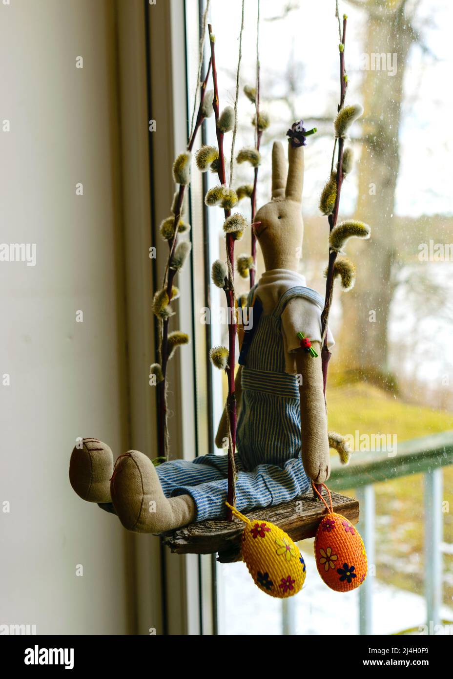 Easter decor with Easter bunny on a swing, decorated with eggs and ...