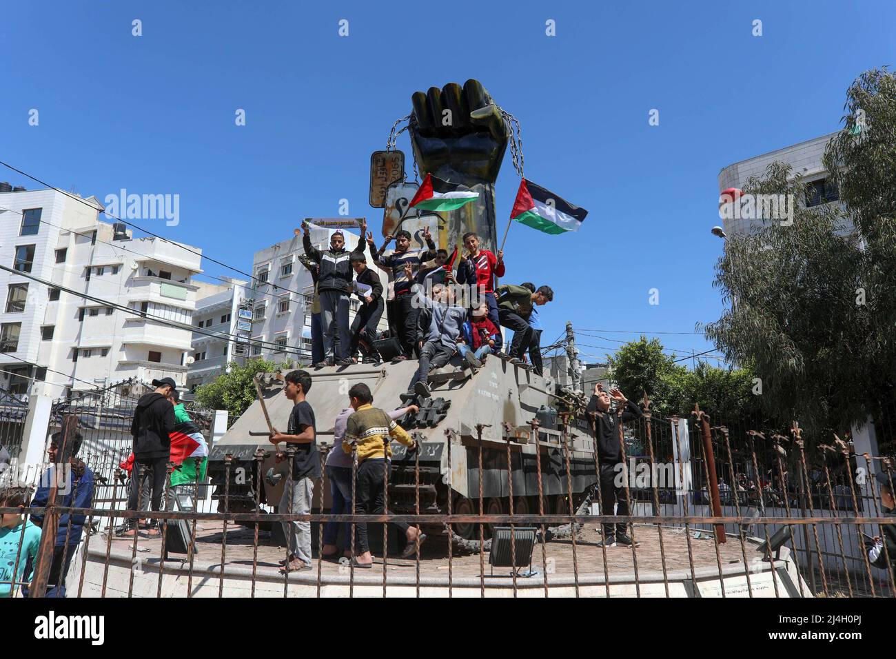 Palestinian children stand above a fake Israeli tank in "Falasteen ...