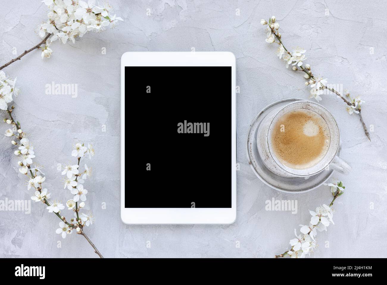 Digital tablet mock-up and spring white cherry blossom flowers and ...