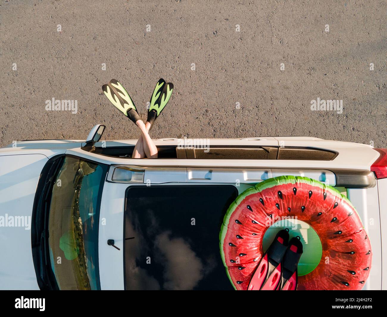 woman legs in flippers stick out from the car window sea vacation ...