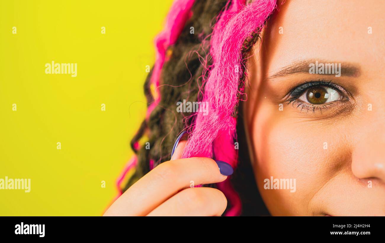 Part of female's face with curly dreadlocks expressing positive emotion ...