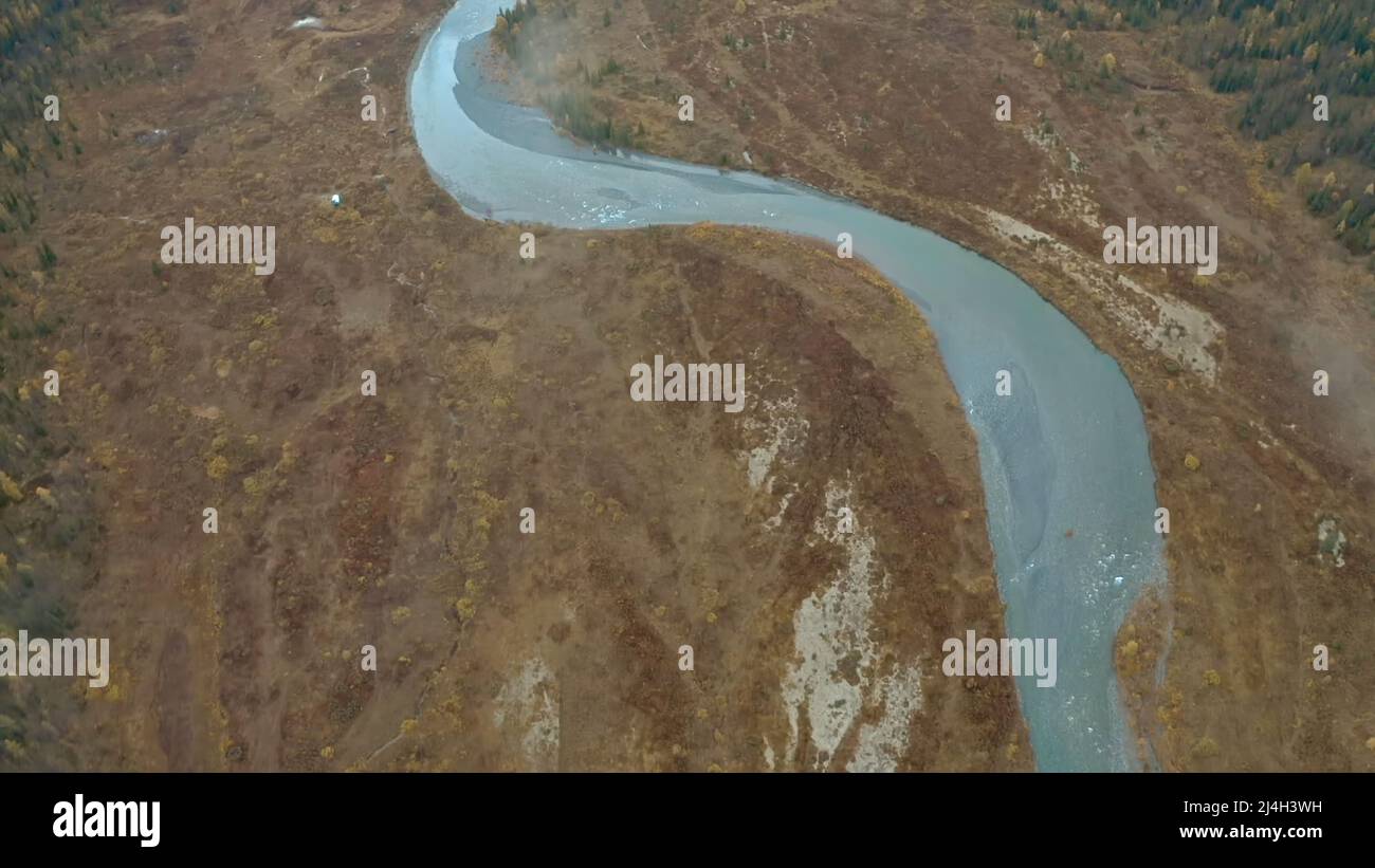 Nature from the height of a drone. Clip. The blue clear winding river ...