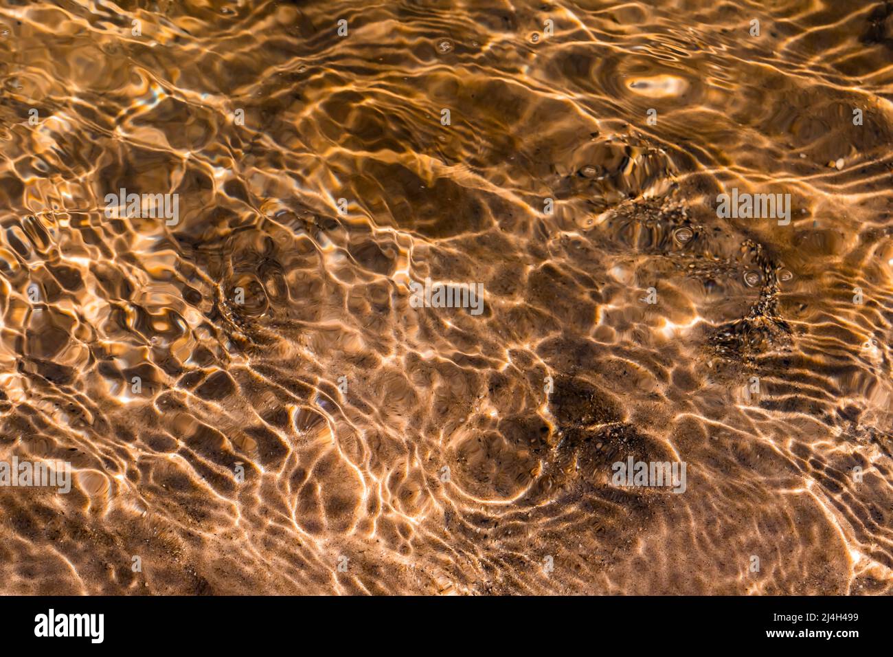 Ripples catching sunlight on the surface of Mitchell Creek, Clay Cliffs ...