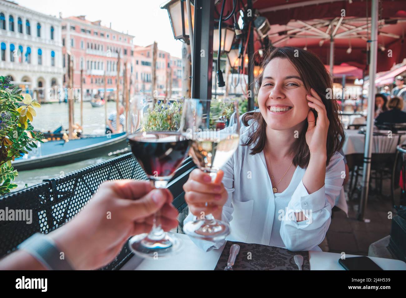 first person point of view couple in cafe outdoors drinking wine ...