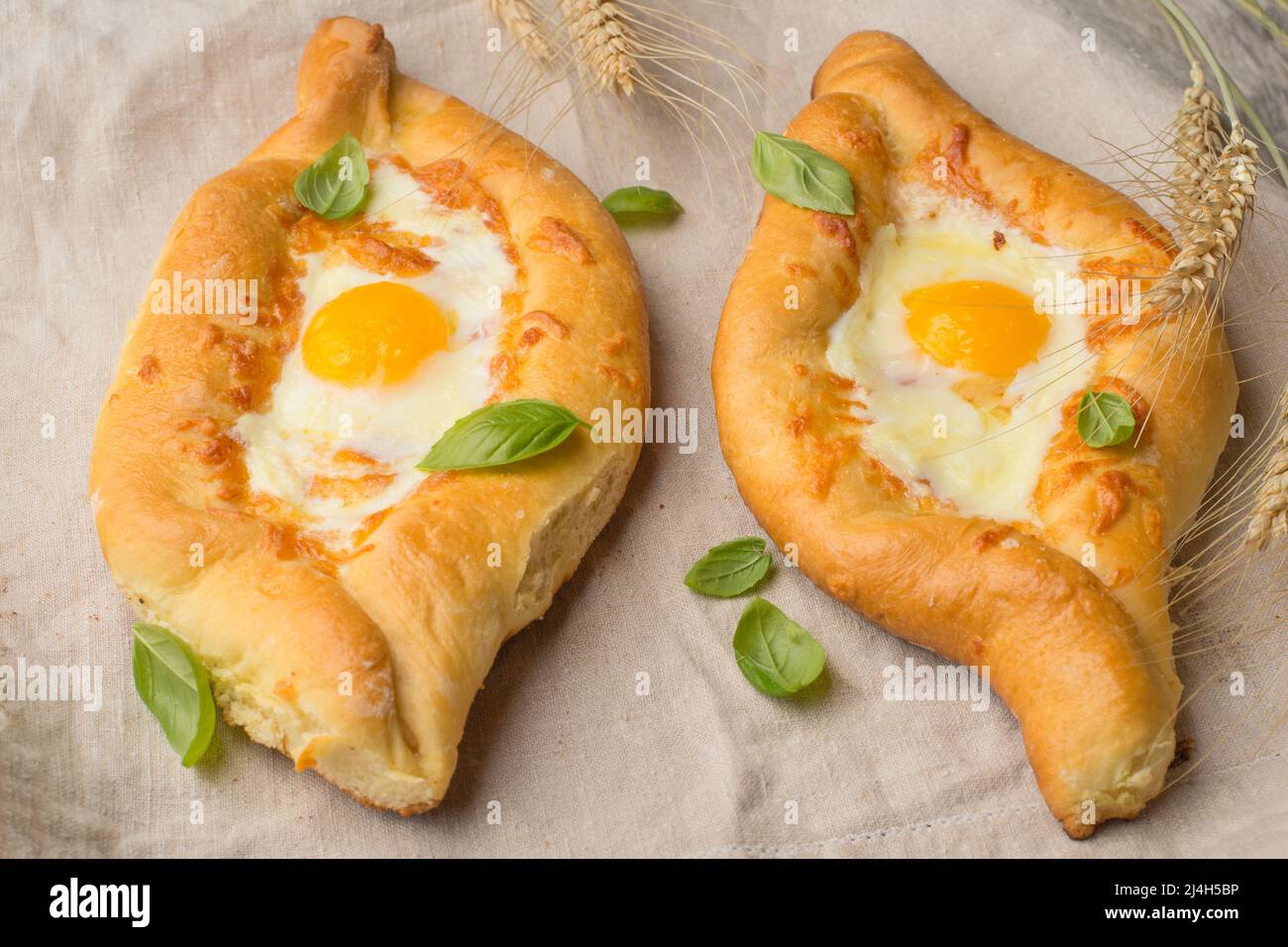Khachapuri traditional Georgian cheese and egg-filled bread Stock Photo ...