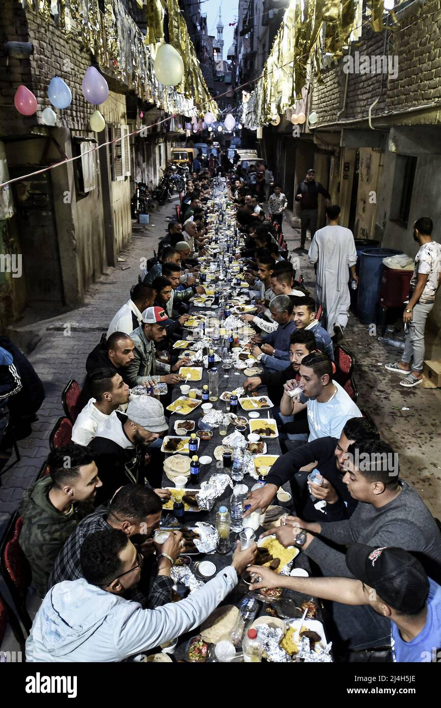 Cairo, Egypt. 15th Apr, 2022. Egyptians attend a mass Iftar gathering ...
