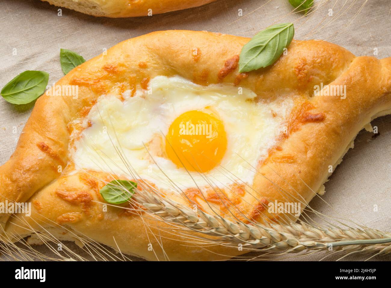 Khachapuri traditional Georgian cheese and egg-filled bread Stock Photo ...