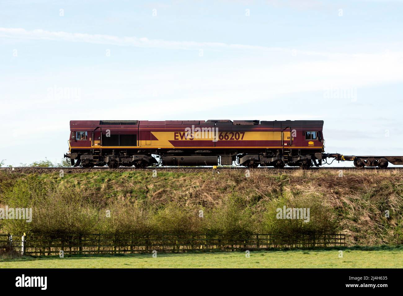 EWS Class 66 diesel locomotive No. 66207 pulling a freight train ...