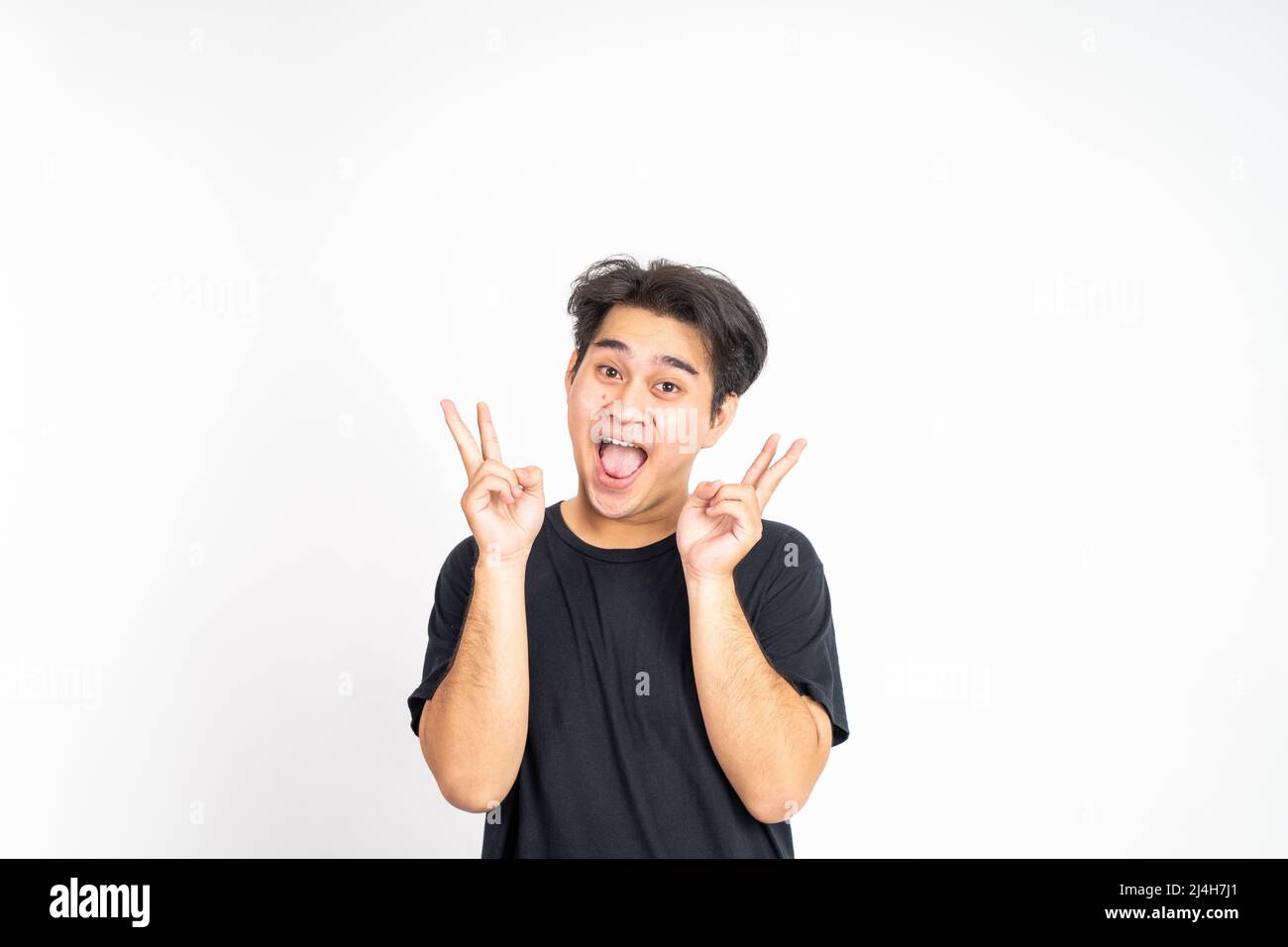 asian man with cute hand gesture making v shape on finger Stock Photo ...