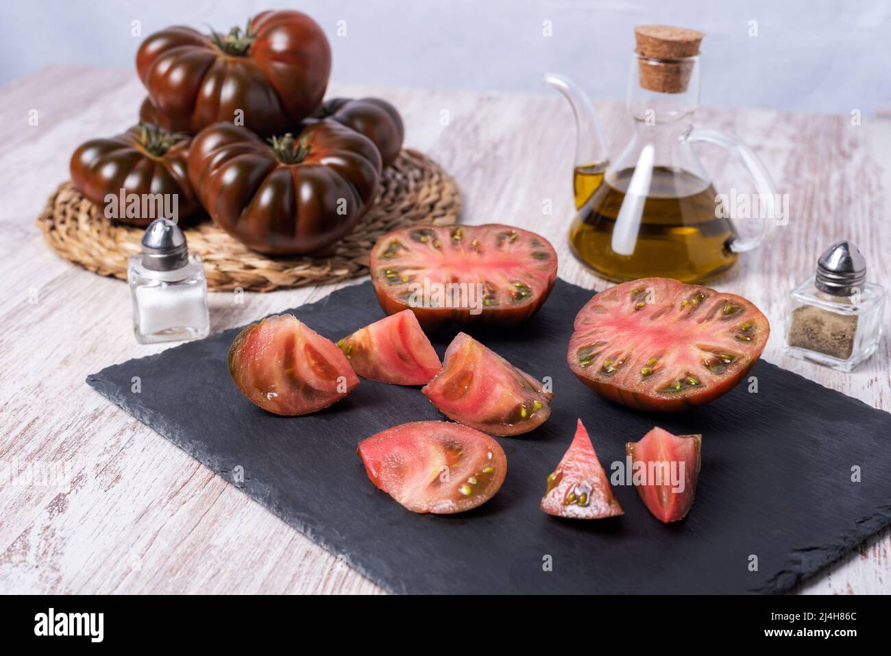 Raf tomato of the black variety, one chopped and the other open in two ...