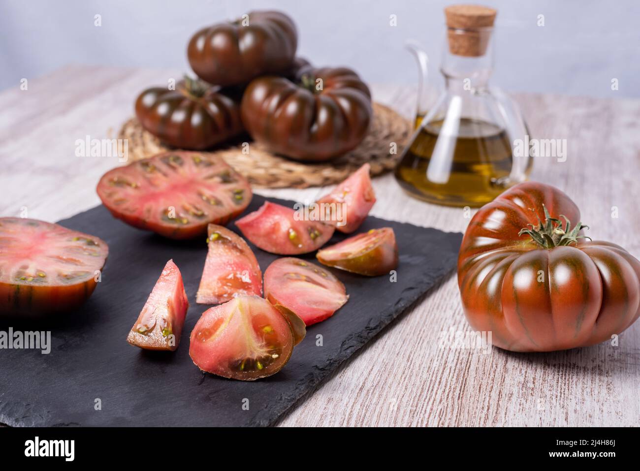 Raf tomato of the black variety, one chopped and the other open in two ...