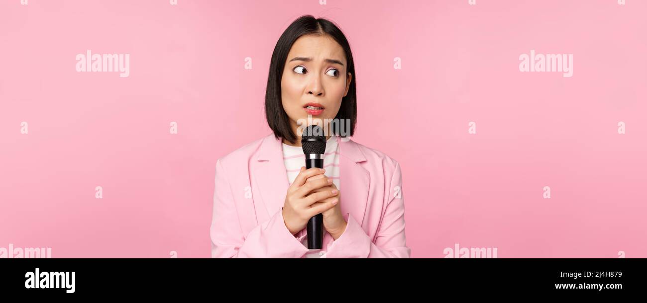 Insecure asian businesswoman giving speech, scared of talking in public ...