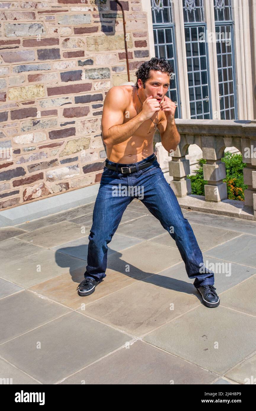 Dressing in jeans and leather sneakers and shirtless, a handsome ...